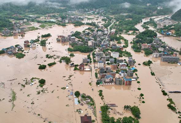 Floods from waning typhoon hit transport, force evacuations in China ...